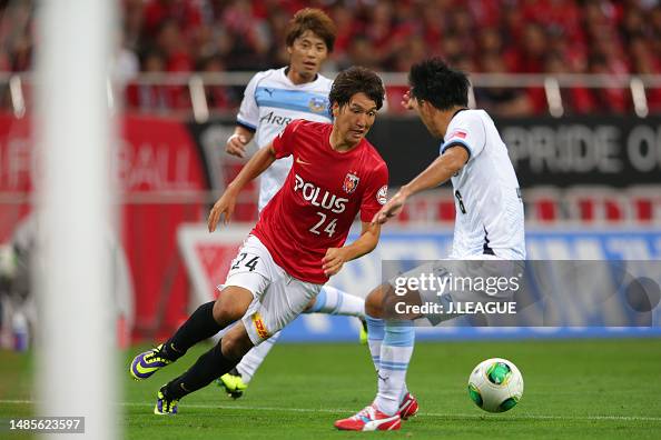 Genki Haraguchi Of Urawa Red Diamonds Takes On Masaki Yamamoto Of