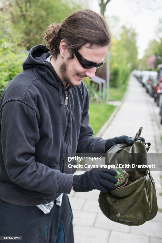 Thief Holding Wallet From A Stolen Handbag High-Res Stock Photo - Getty ... Thief Holding Wallet From A Stolen Handbag High-Res Stock Photo - Getty ...