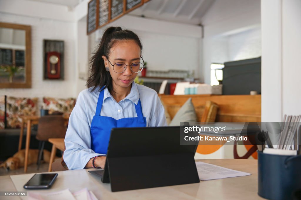 Asian Restaurant Manager Analyzing Financial Reports High-Res Stock ... Asian Restaurant Manager Analyzing Financial Reports High-Res Stock ...