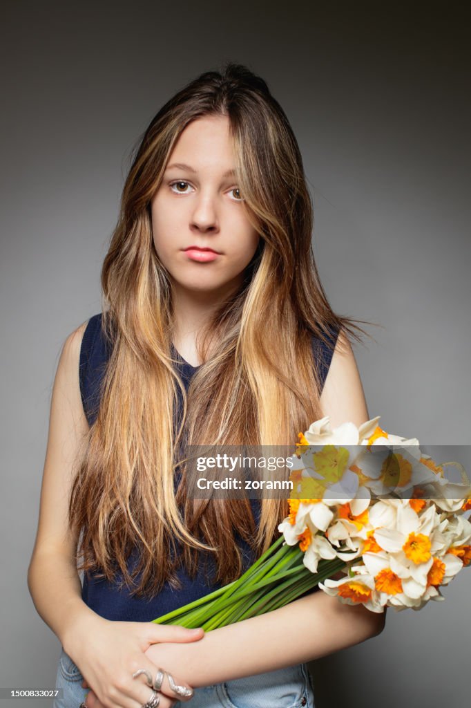 Teenage Girl With Long Naturally Blond Hair Looking At Camera And