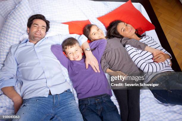 60 Overhead View Smiling Mother And Daughter Hugging On Bed Stock