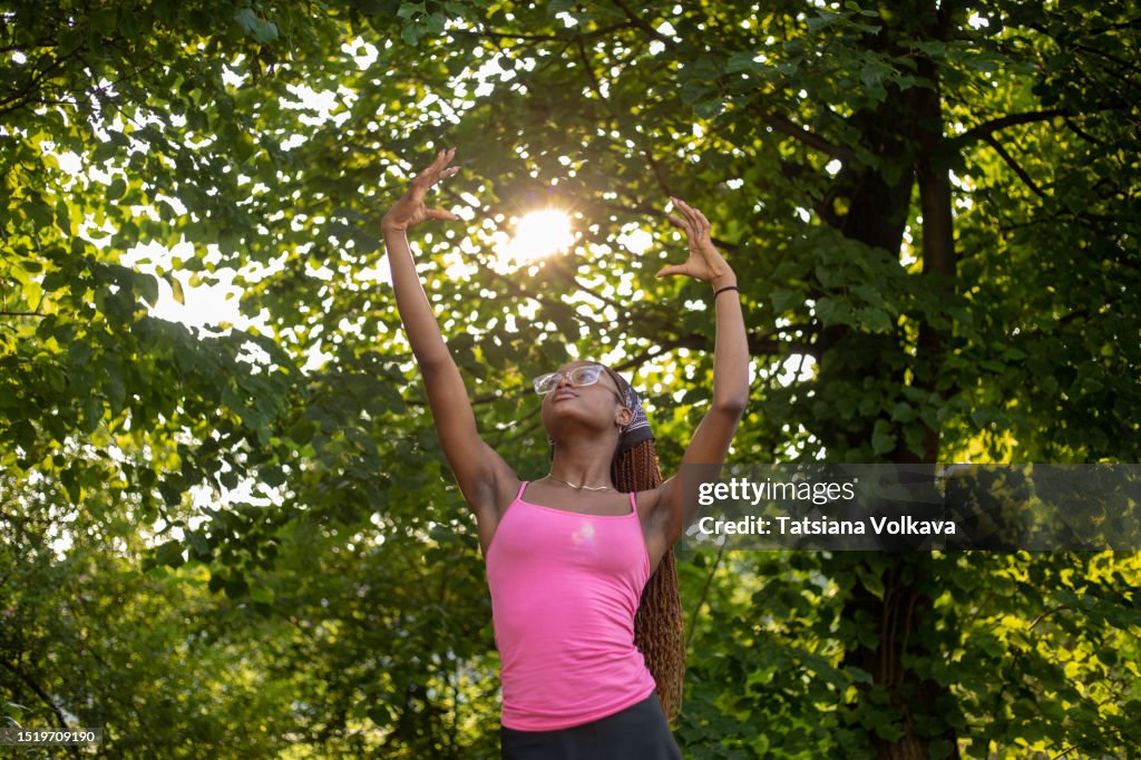 Serene Photo Of Young Black Lady Wearing Pink Tank Top And Bandana