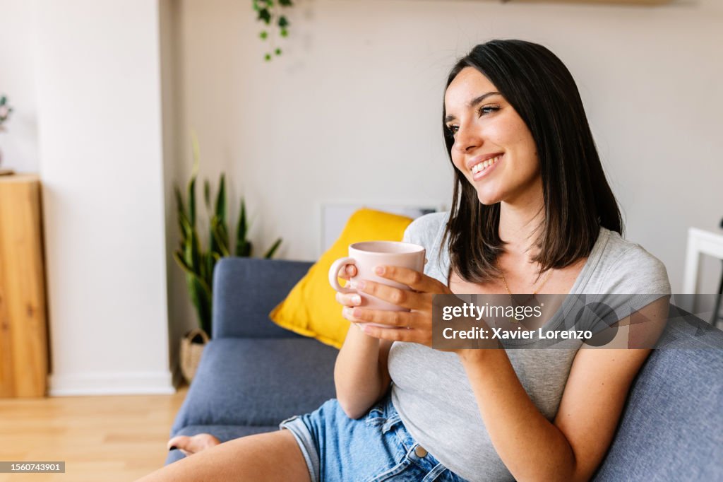 Beautiful Young Adult Woman Daydreaming While Holding Coffee Cup ... Beautiful Young Adult Woman Daydreaming While Holding Coffee Cup ...