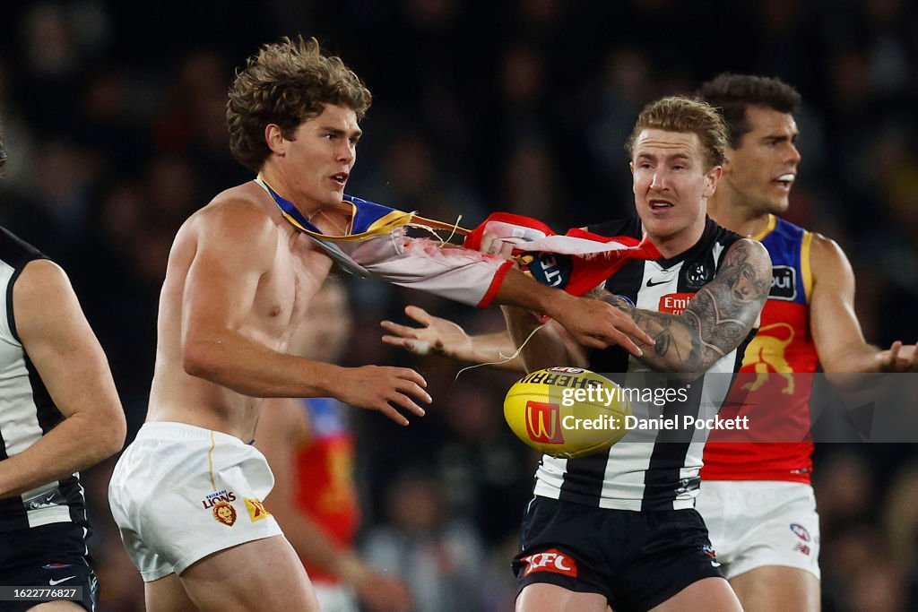 Deven Robertson Of The Lions Kicks The Football Whilst Being Tackled