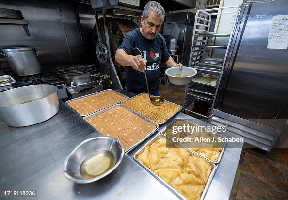 Asem Abusir Owner Of Knafeh Cafe Puts Syrup On Helbeh A News Photo Getty Images