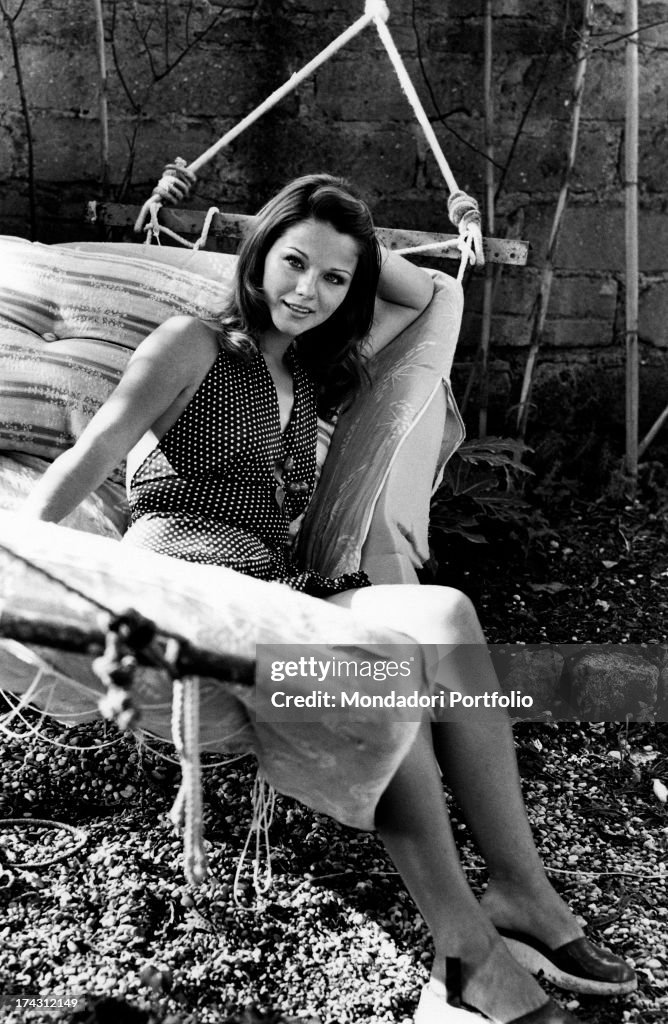 Italian Actress Agostina Belli Smiling And Posing Sitting On A Foto