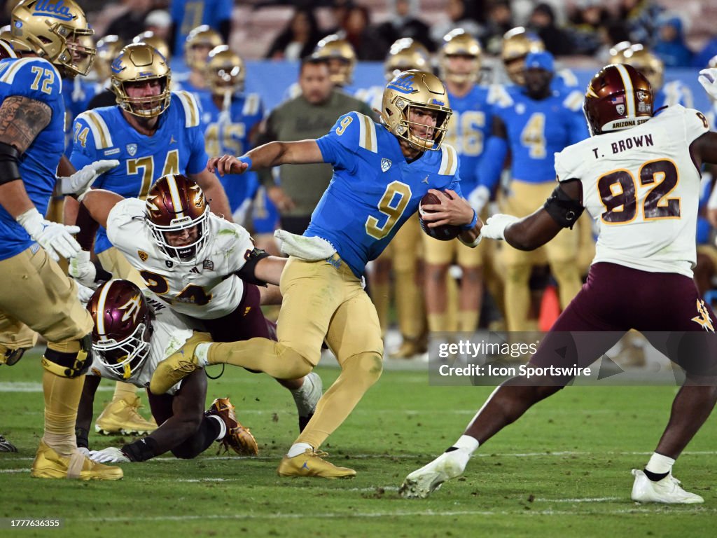 Bruins quarterback Collin Schlee gains yards running with the ball ... Bruins quarterback Collin Schlee gains yards running with the ball ...