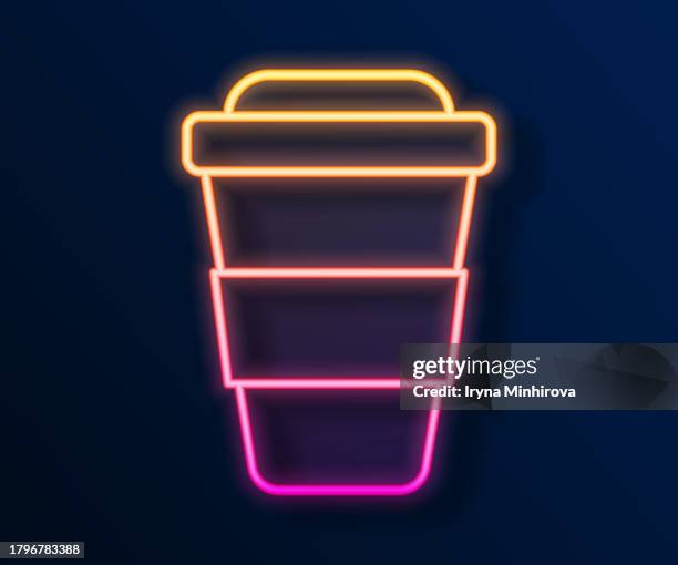 Glowing neon line Coffee cup to go icon isolated on black background ...