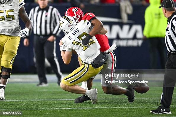 Georgia Tech quarterback Haynes King fumbles the ball after being hit ... Georgia Tech quarterback Haynes King fumbles the ball after being hit ...