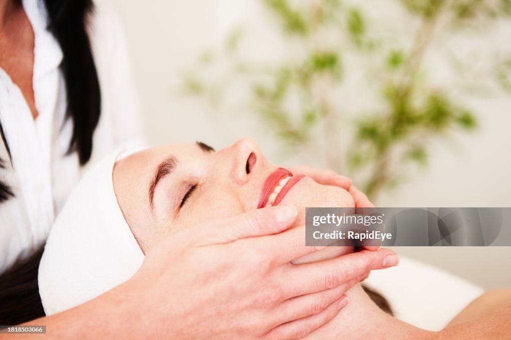 Beautiful Woman Receives A Relaxing Face Massage In A Beauty Salon High