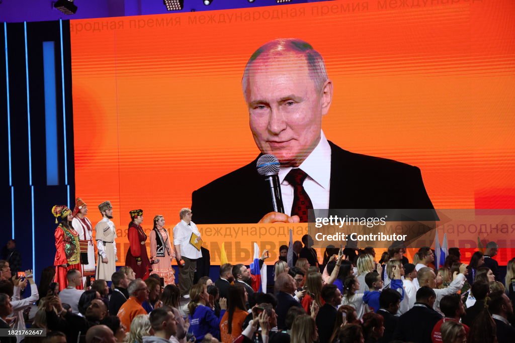 Russian President Vladimir Putin Seen On The Screen While The We Are