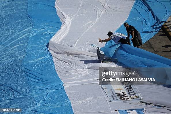 Supporters of Argentina's President-elect Javier Milei put a placard ... Supporters of Argentina's President-elect Javier Milei put a placard ...