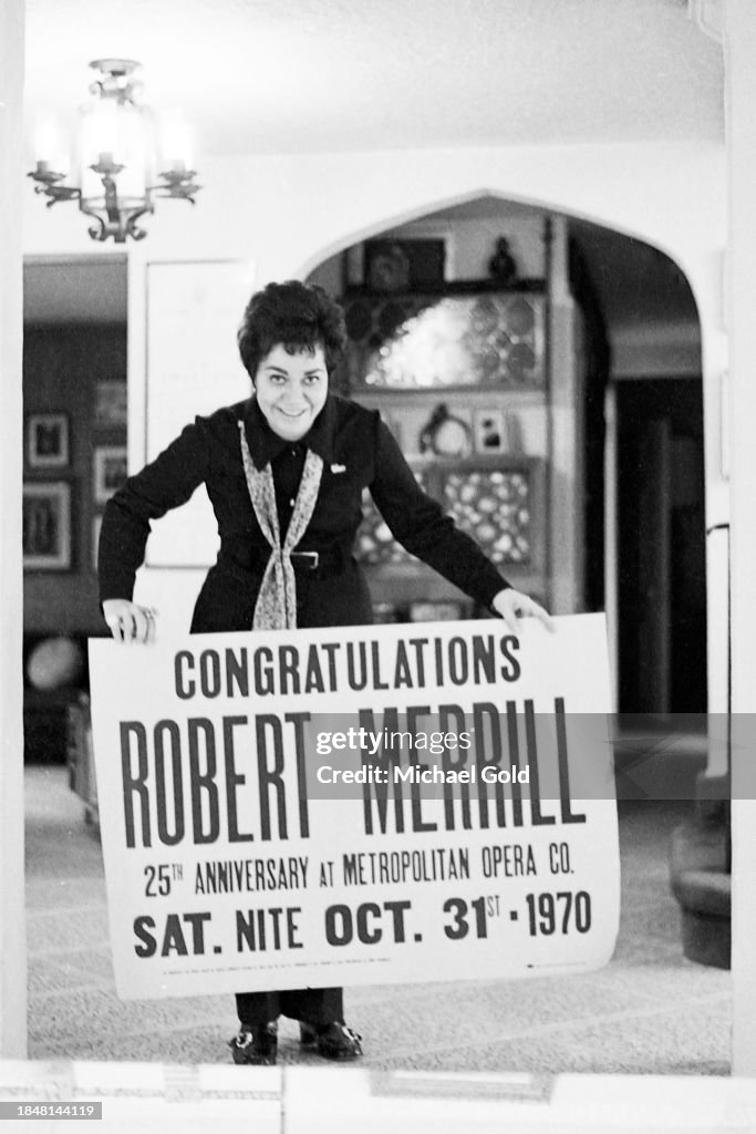 Robert Merrill's wife, Marion, holding congratulatory poster for ... Robert Merrill's wife, Marion, holding congratulatory poster for ...