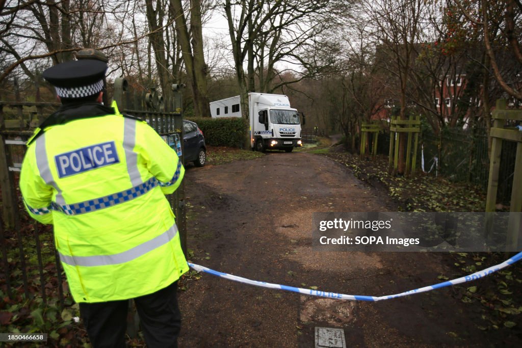 A police officer replaces the police tape after letting in the police ... A police officer replaces the police tape after letting in the police ...