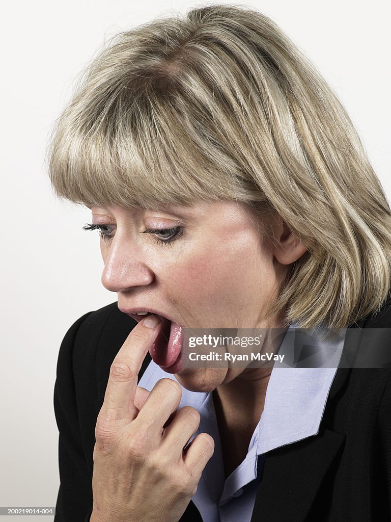 Mature Woman With Finger In Mouth Gagging Photo Getty Images