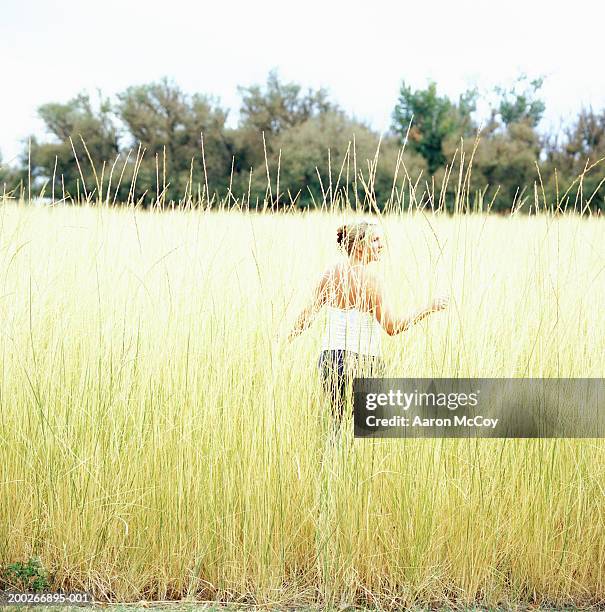 Women Walking Through Tall Grass Photos And Premium High Res Pictures