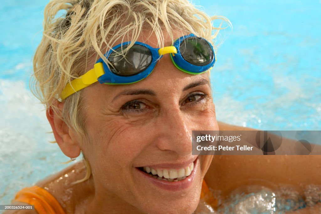 Mature Woman In Pool With Goggles On Head Smiling Portrait Closeup High