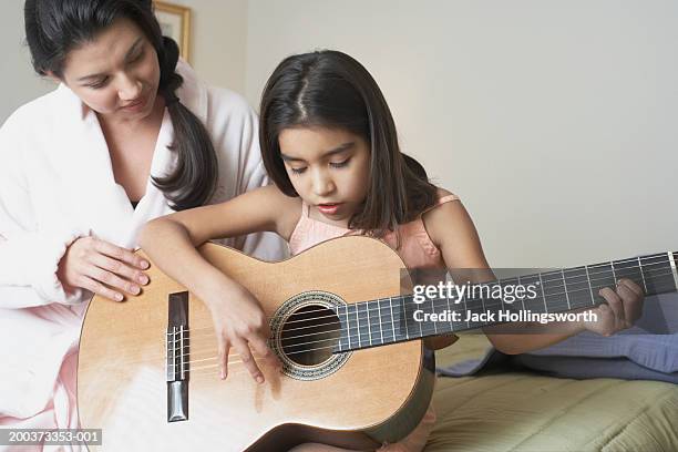 Mom And Daughter Playing Guitar Photos And Premium High Res Pictures