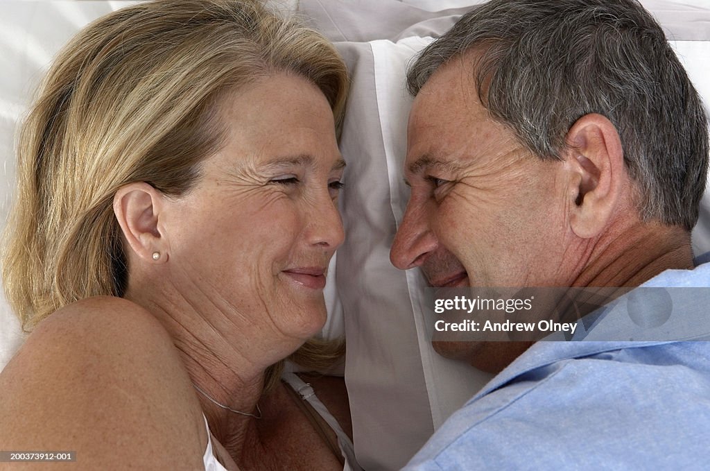 Mature Couple Lying In Bed Smiling At Each Other Closeup High Res Stock