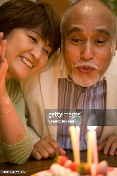Man Blowing Out Birthday Candles Photos And Premium High Res Pictures Getty Images