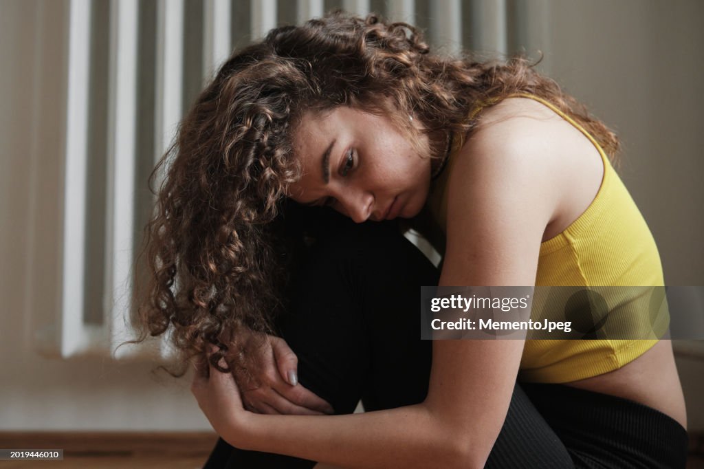 Sad Lonely Woman Sitting On Floor Hugging Knees Feeling Depressed High