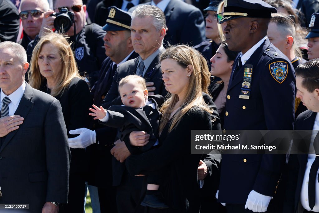 Stephanie Diller, the widow of NYPD officer Jonathan Diller, carries ... Stephanie Diller, the widow of NYPD officer Jonathan Diller, carries ...