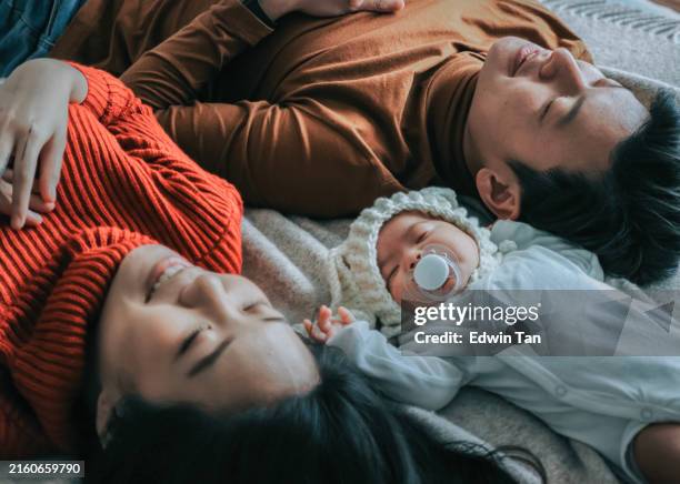 60 Overhead View Smiling Mother And Daughter Hugging On Bed Stock