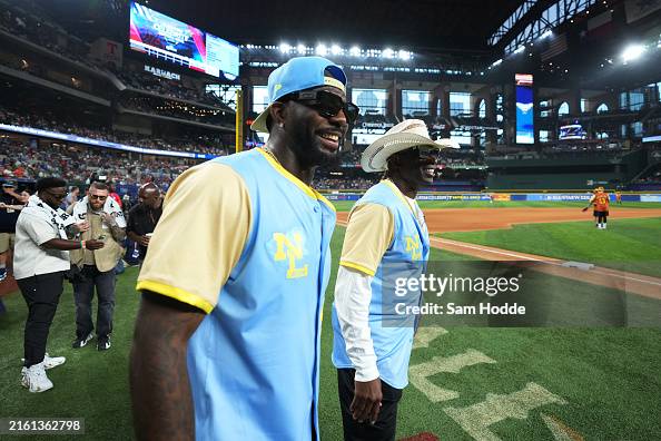 Deion Sanders of the National team and Dez Bryant chat prior to the ... Deion Sanders of the National team and Dez Bryant chat prior to the ...