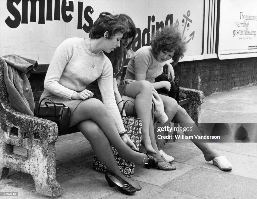 Footsore office girls rest their weary feet in Bow, East London, as ... Footsore office girls rest their weary feet in Bow, East London, as ...