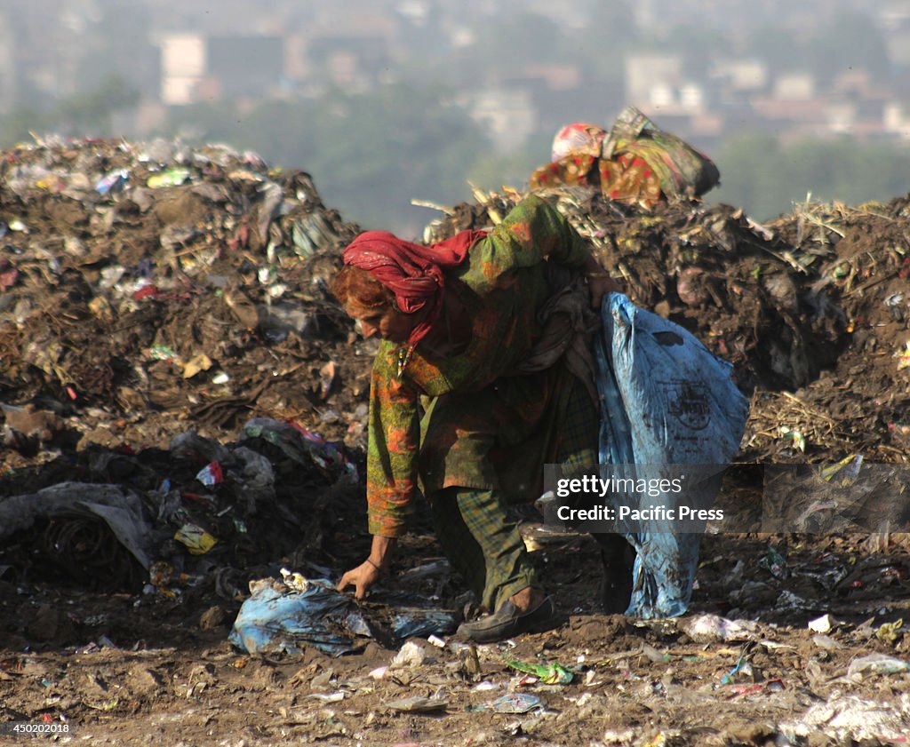 A Pakistani Woman Collects Useful Items From Garbage A Dump Site In