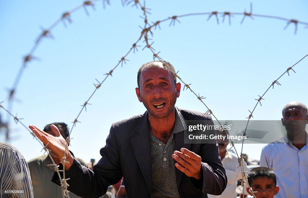 Syrian Refugees Wait To Cross Into Turkey At The Border September 22