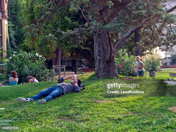 A Woman Lying Under The Tree Photos And Premium High Res Pictures