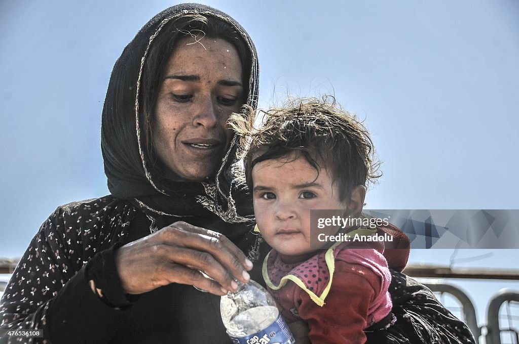 A Syrian Woman And Her Daughter Cross Into Turkey From The Borderline