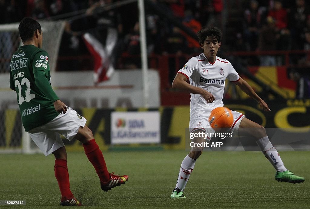 Carlos Emilio Orrantia of Toluca vies for the ball with Juan Carlos ... Carlos Emilio Orrantia of Toluca vies for the ball with Juan Carlos ...