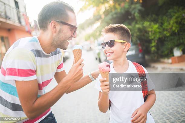 Father And Son Eating Ice Cream Stock Fotos Und Bilder Getty Images