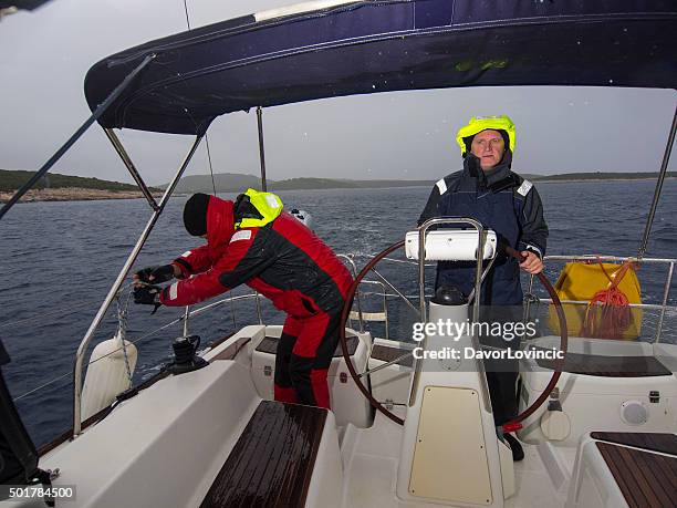 Tim building Business man sailing on rainy weather, Croatia 이미지 ...