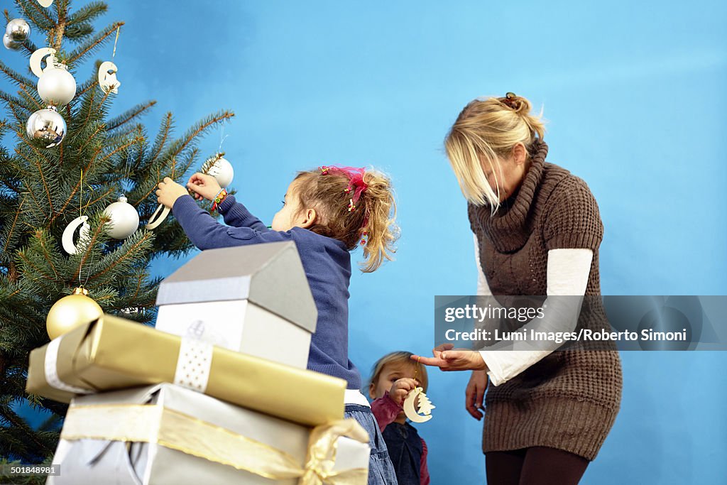Mother And Two Girls Decorating Christmas Tree Munich Bavaria Germany