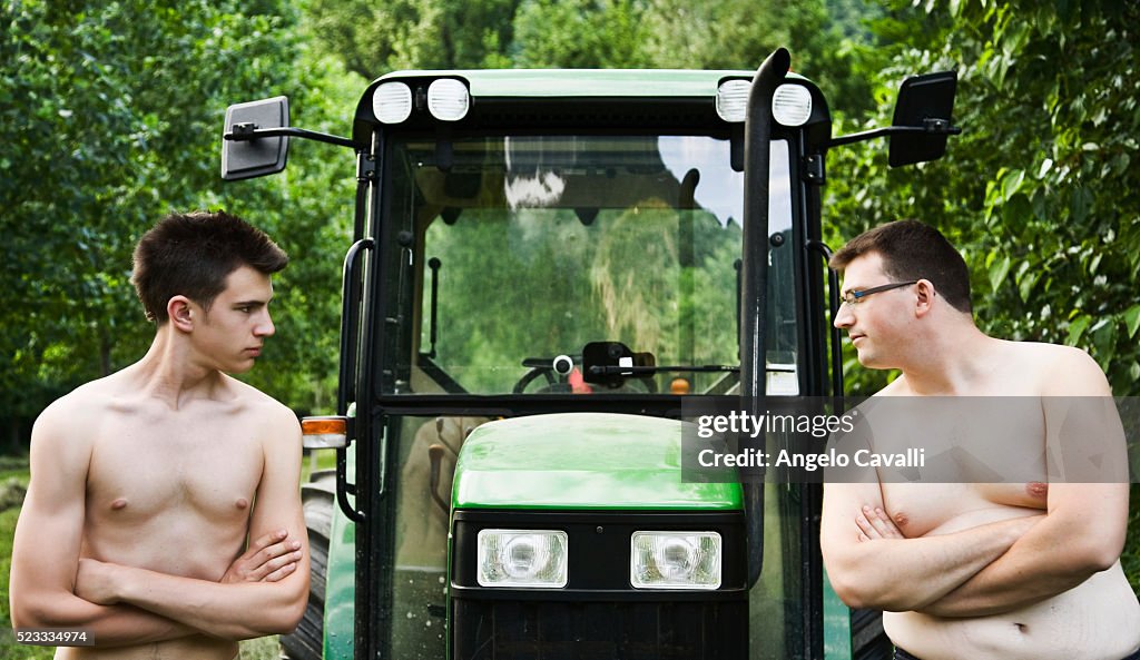 Two Men Staring At Each Other Across A Tractor High-Res Stock Photo ... Two Men Staring At Each Other Across A Tractor High-Res Stock Photo ...