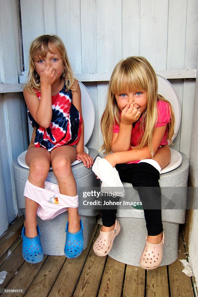 Girls Sitting On Toilets Stockfoto Getty Images