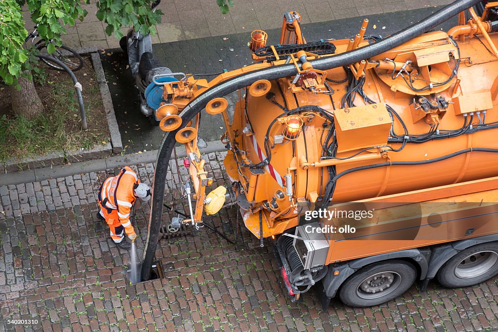 Worker And Sewage Truck Highangle View High-Res Stock Photo - Getty Images Worker And Sewage Truck Highangle View High-Res Stock Photo - Getty Images