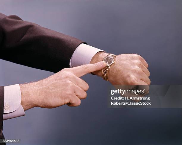 Pointing At Wrist Watch Photos and Premium High Res Pictures - Getty Images Pointing At Wrist Watch Photos and Premium High Res Pictures - Getty Images