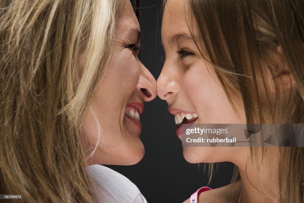 Closeup Of A Mother And Daughter Rubbing Their Noses Together High Res