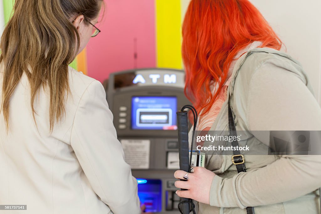 Two Young Blind Women Using A Bank Atm High-Res Stock Photo - Getty Images Two Young Blind Women Using A Bank Atm High-Res Stock Photo - Getty Images