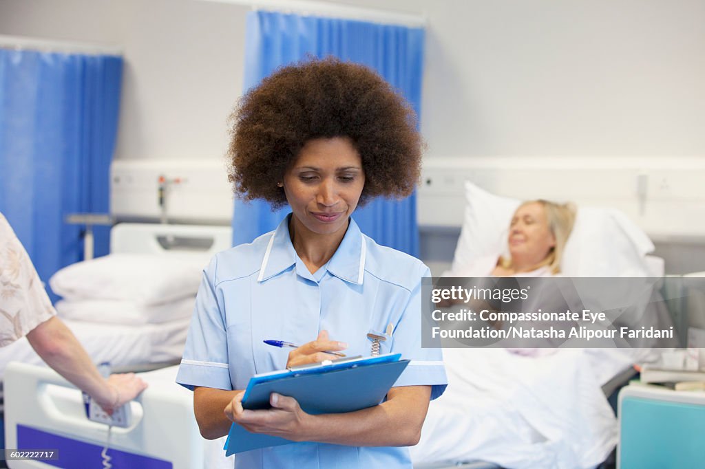 Nurse Reviewing Patient Records In Hospital High-Res Stock Photo ... Nurse Reviewing Patient Records In Hospital High-Res Stock Photo ...
