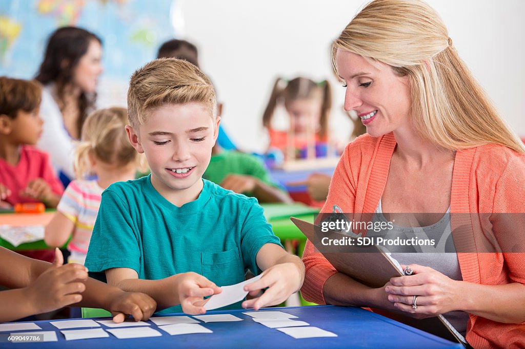 Young Boy Using Flashcards To Study With Teacher High-Res Stock Photo ... Young Boy Using Flashcards To Study With Teacher High-Res Stock Photo ...
