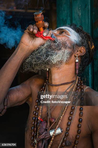 Hindu Sadhu holy man smoking charas pipe Kathmandu temple Nepal ...