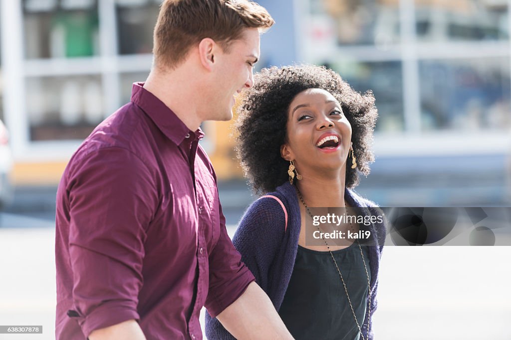 Happy Interracial Couple Walking Holding Hands Laughing High Res Stock