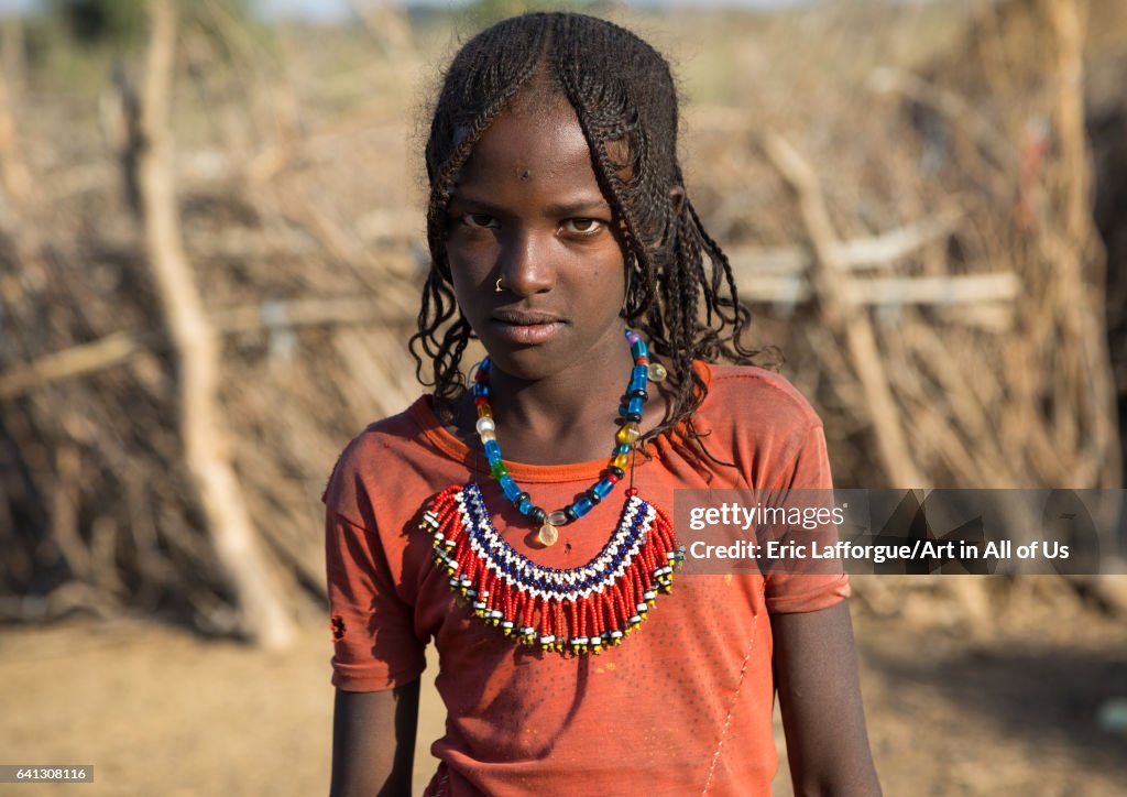 Portrait Of An Afar Tribe Girl With Braided Hair And Beaded Necklace
