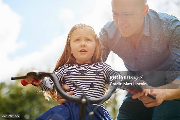 Dad Teach Daughter To Ride Bicycle Photos And Premium High Res Pictures