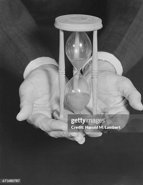 Man Holding Hourglass Photos and Premium High Res Pictures - Getty Images Man Holding Hourglass Photos and Premium High Res Pictures - Getty Images